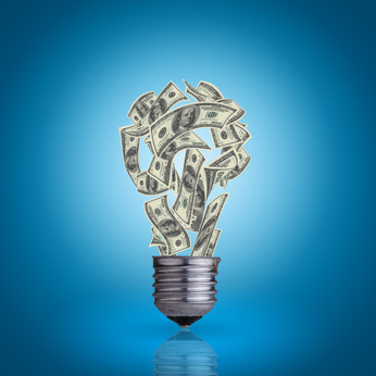 light bulb with money banknotes inside it on blue background - Winnow ...